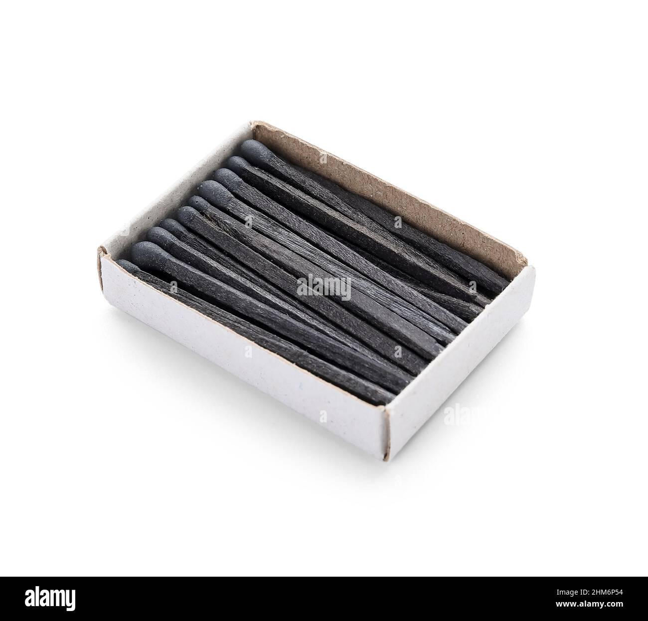 Box with black matchsticks on white background Stock Photo - Alamy