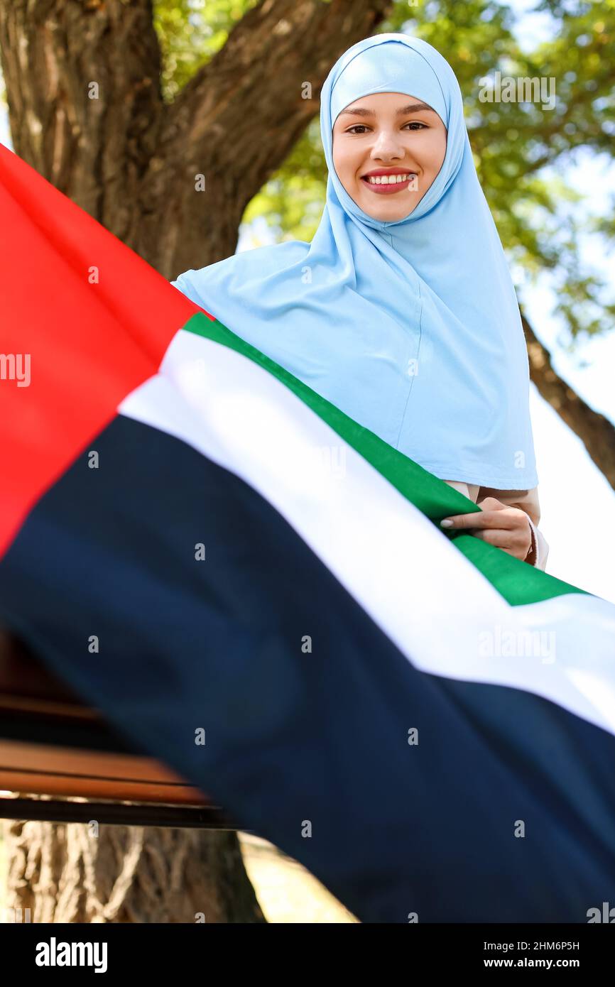 Beautiful Muslim woman with UAE flag sitting on bench in park Stock ...