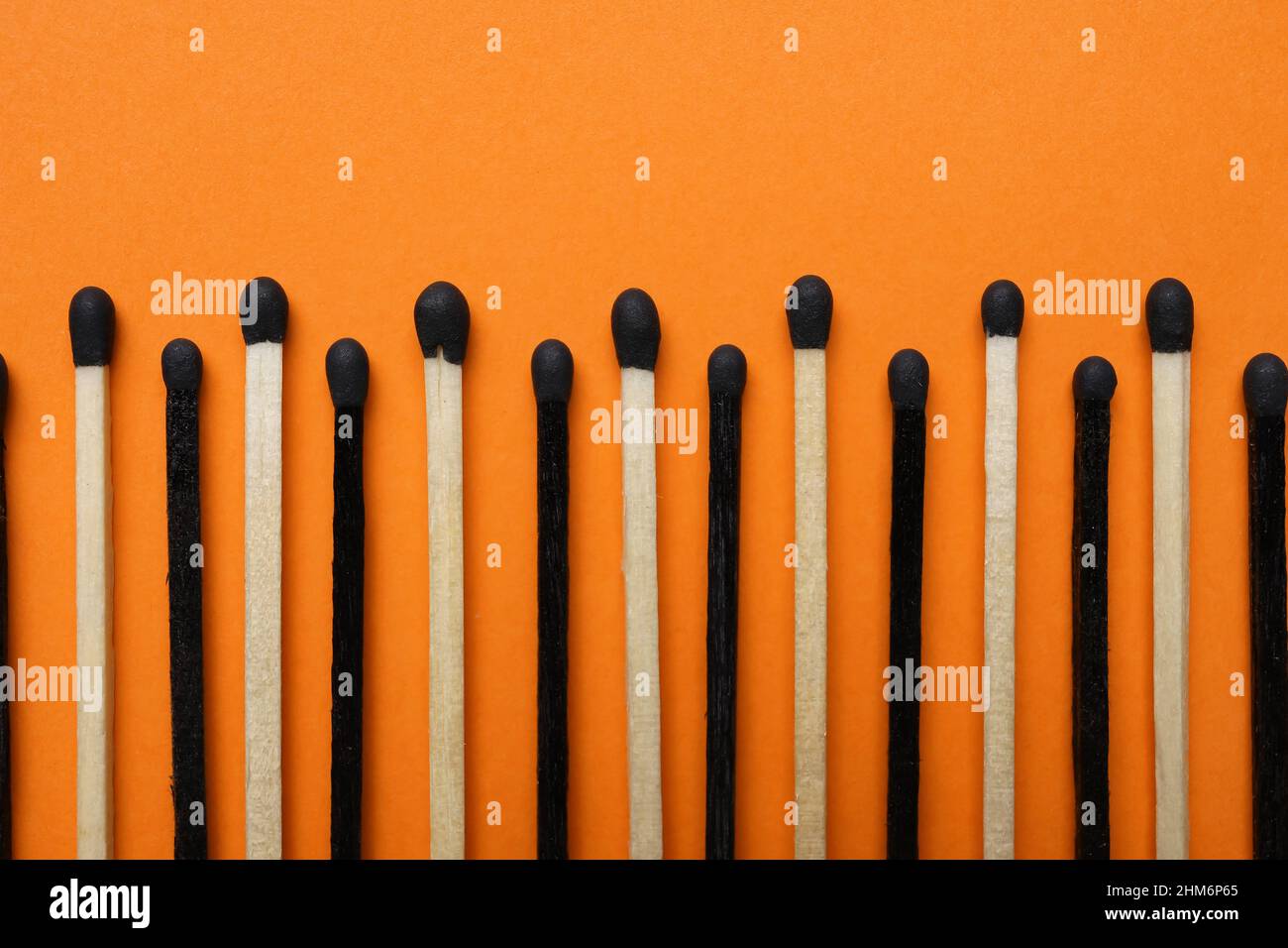 Different new matchsticks on orange background Stock Photo - Alamy