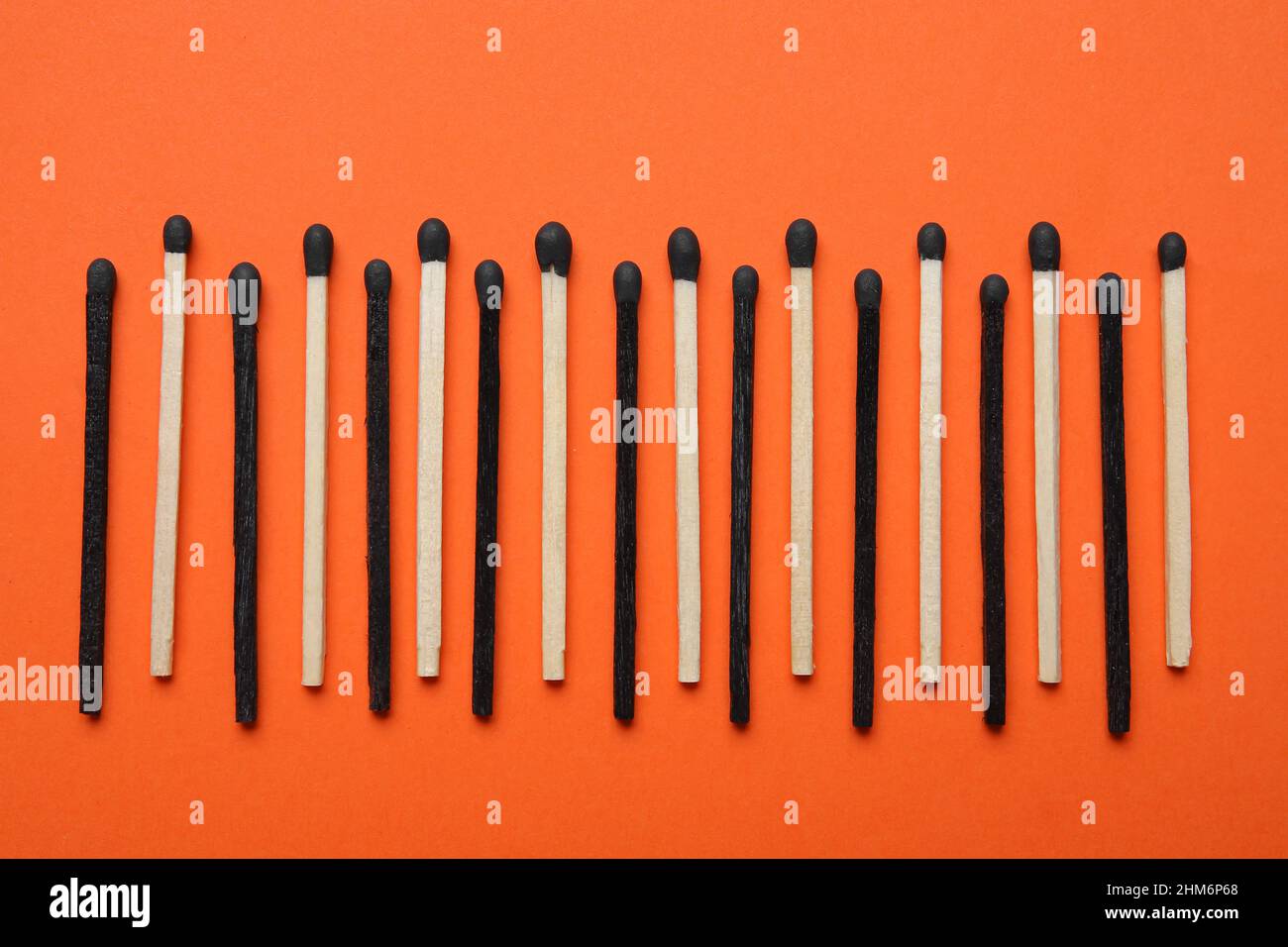 Different new matchsticks on orange background Stock Photo - Alamy