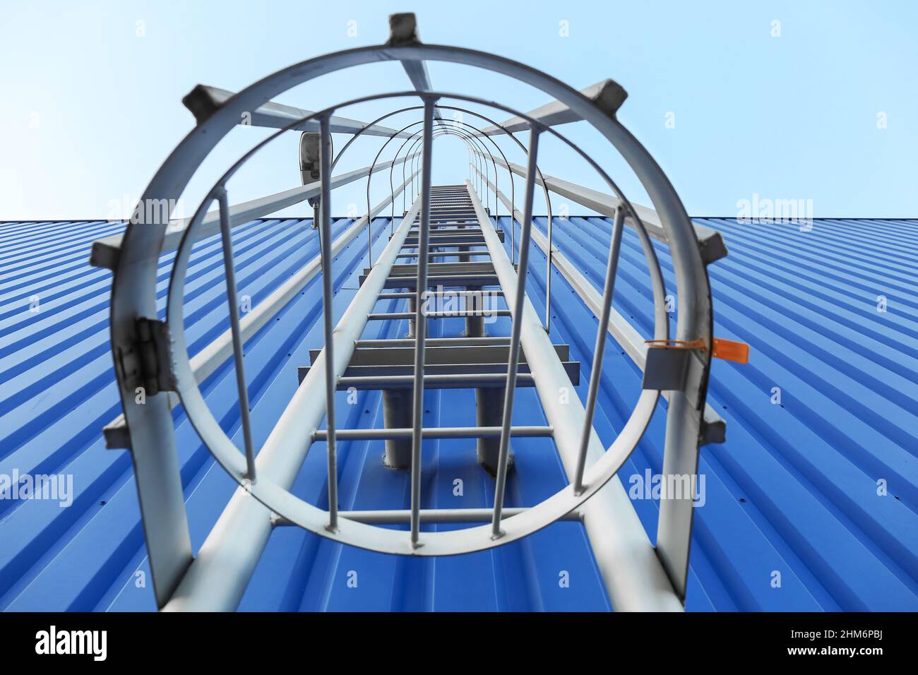 Fire escape metal ladder of blue building outdoors, closeup Stock Photo ...