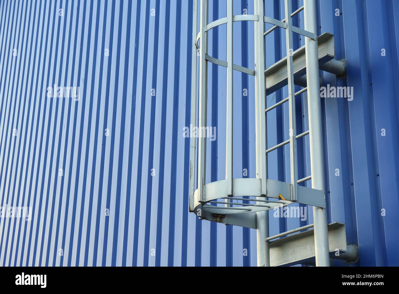 Fire escape metal ladder of blue building outdoors, closeup Stock Photo ...