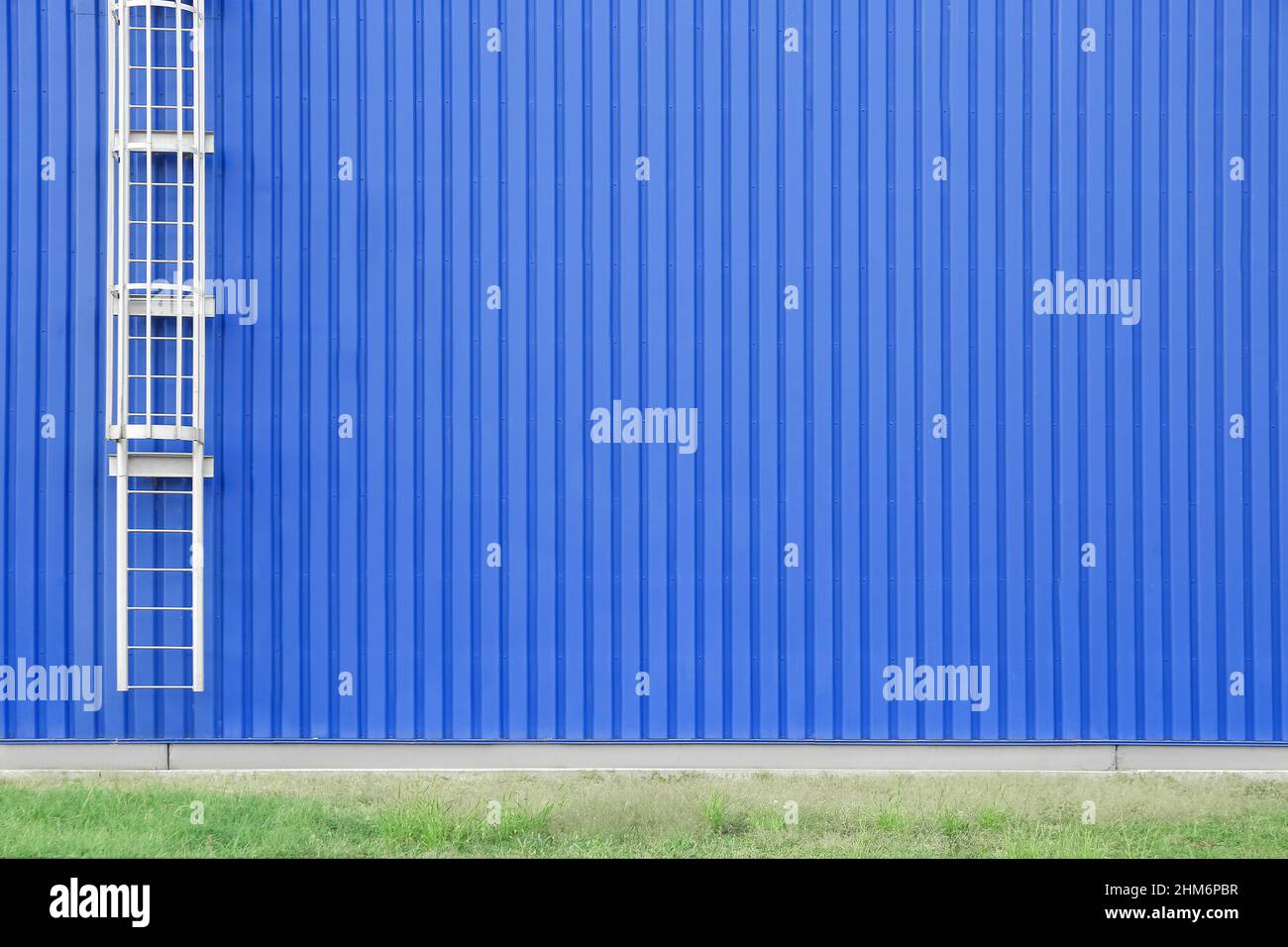 Fire escape metal ladder of blue building outdoors Stock Photo - Alamy