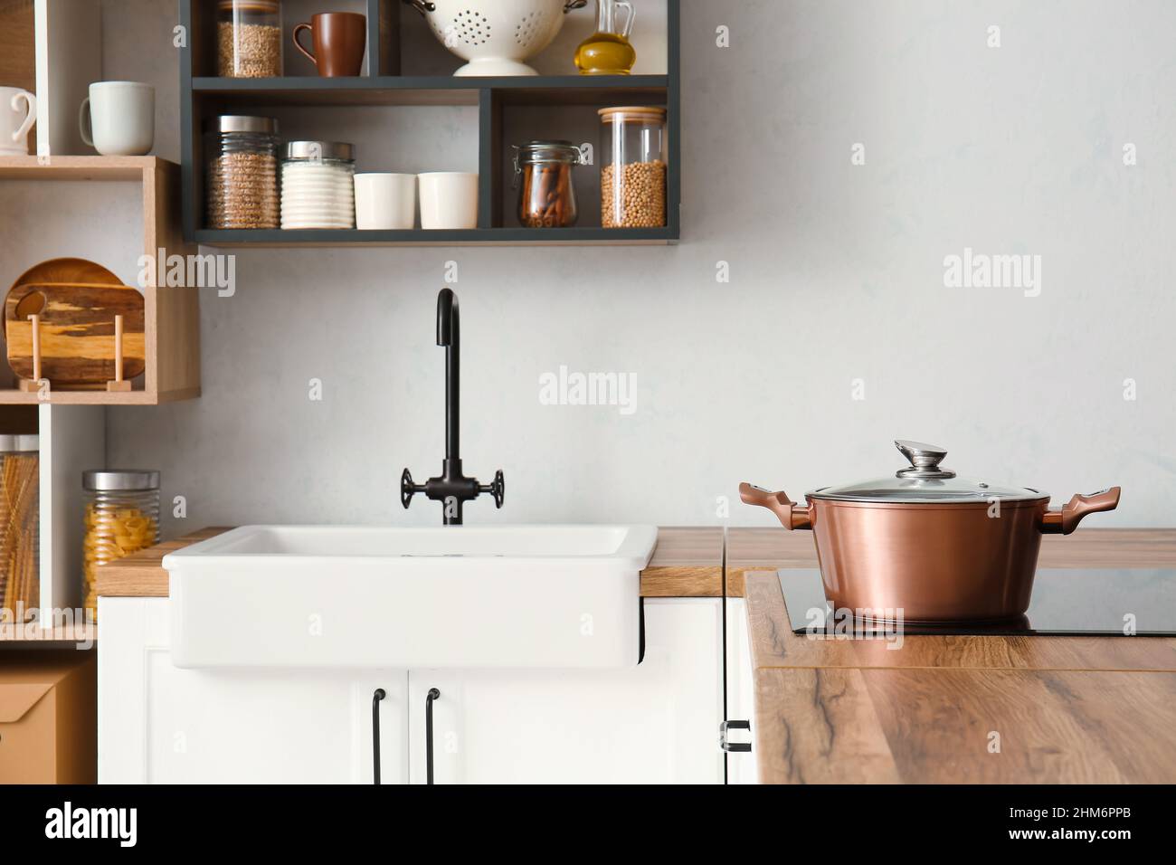 Shiny cooking pot on stove in light kitchen Stock Photo - Alamy