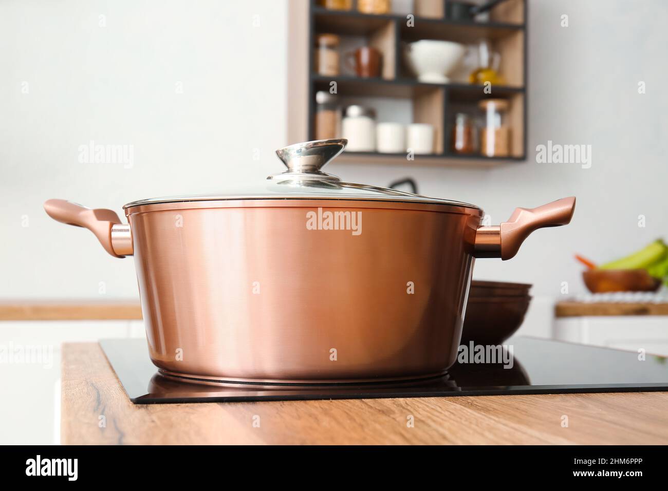 Shiny cooking pot on stove in light kitchen, closeup Stock Photo - Alamy