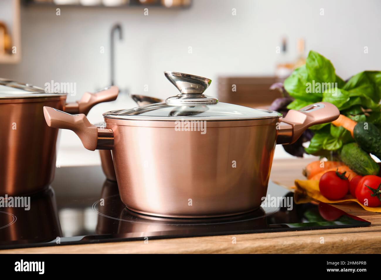 Shiny cooking pot on stove in modern kitchen, closeup Stock Photo - Alamy