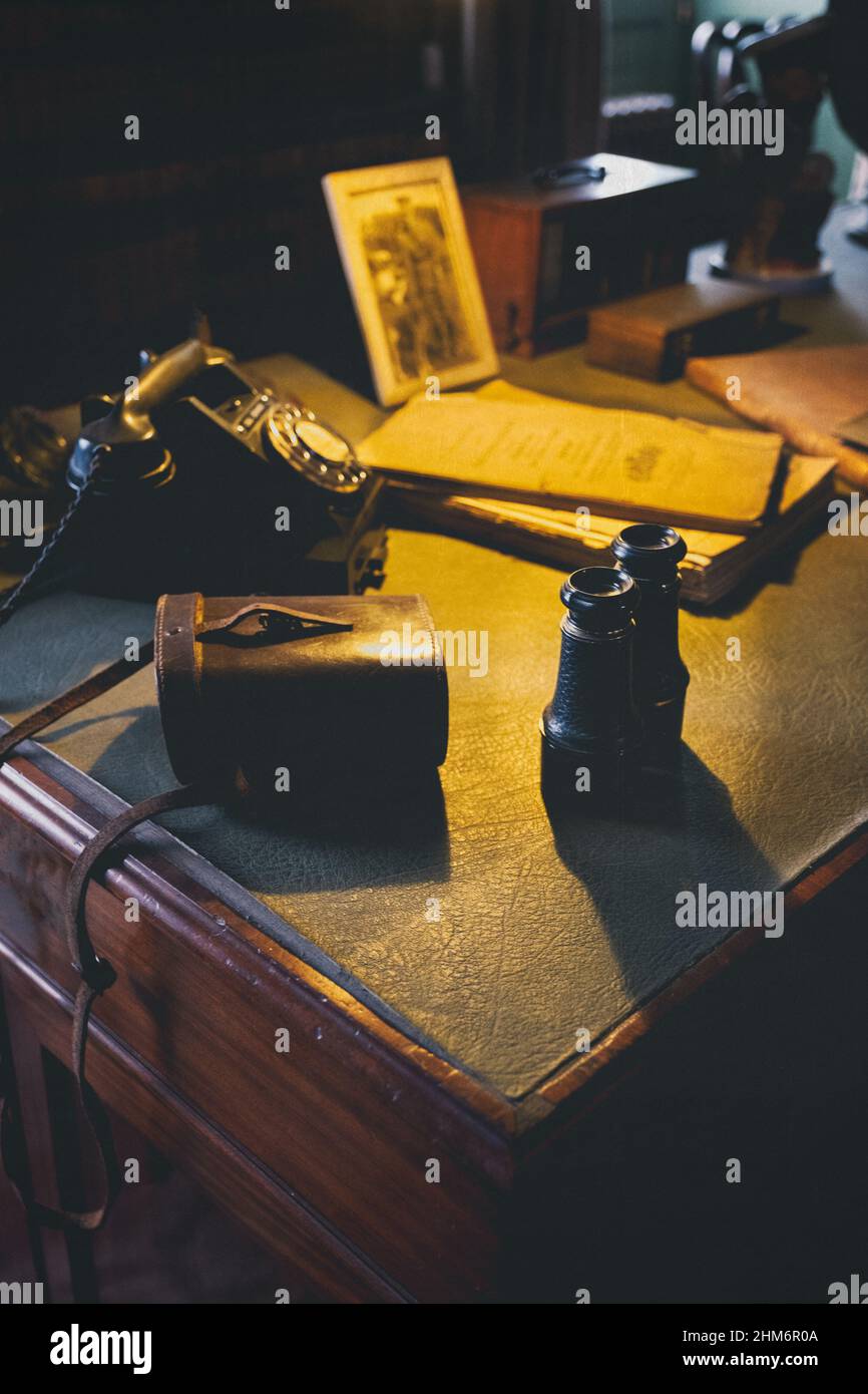1940's World War II writing desk with binoculars and old fashioned ...