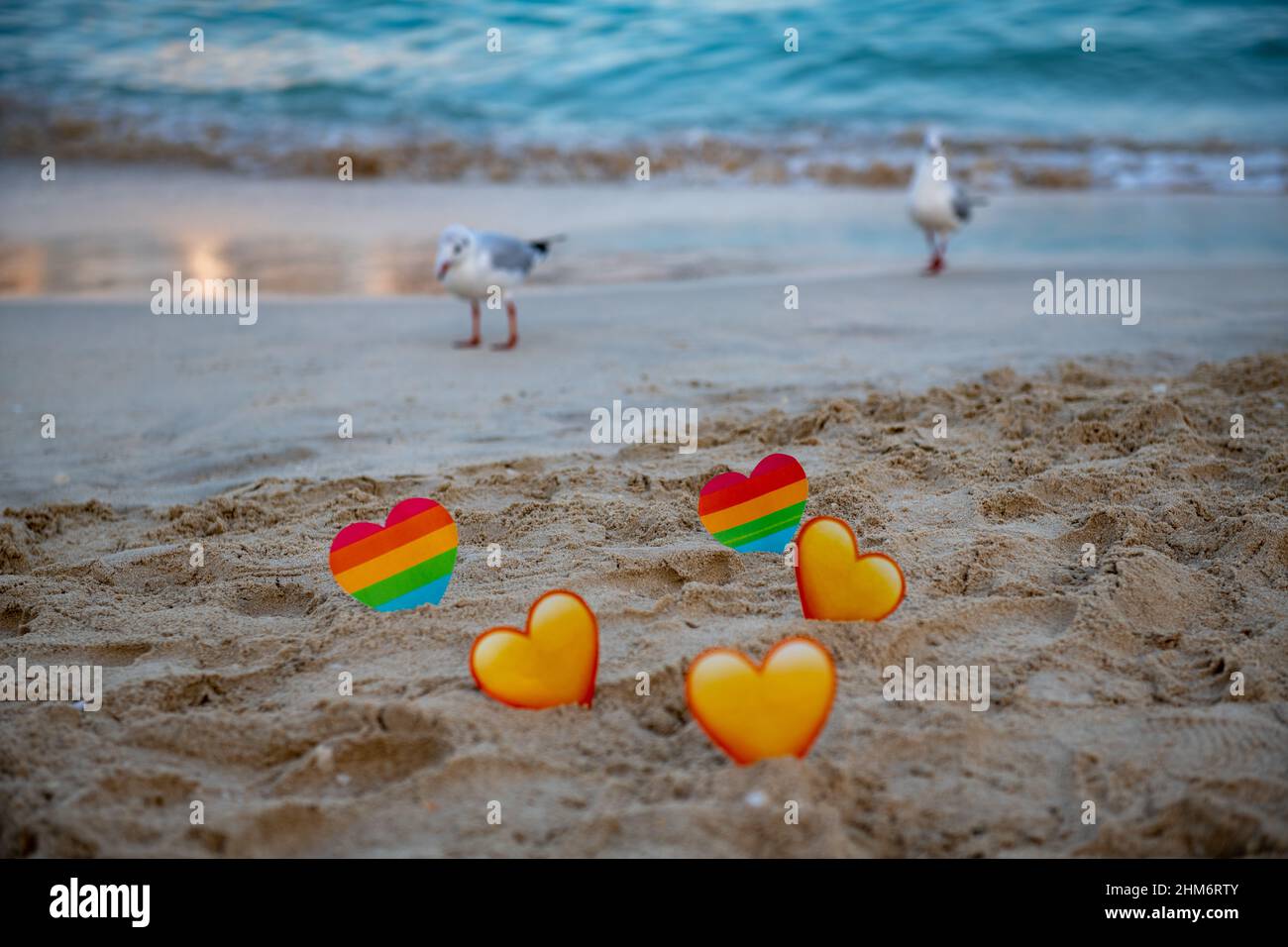 birds and lgbt and yellow hearts in the sand stand Stock Photo - Alamy