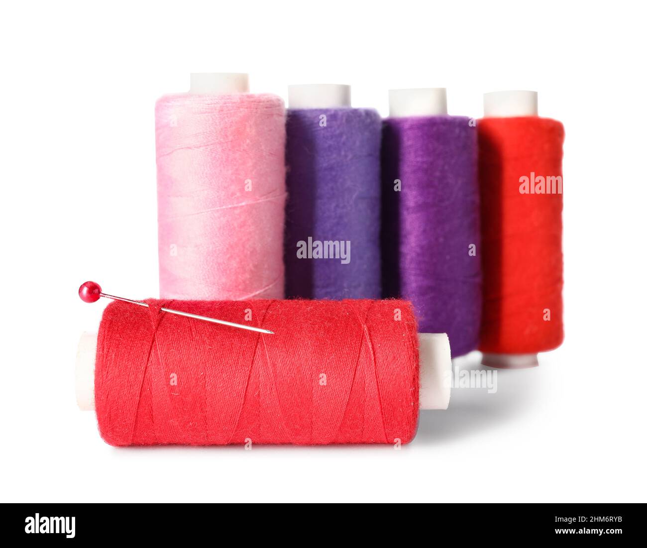 Different sewing threads with needle on white background Stock Photo ...