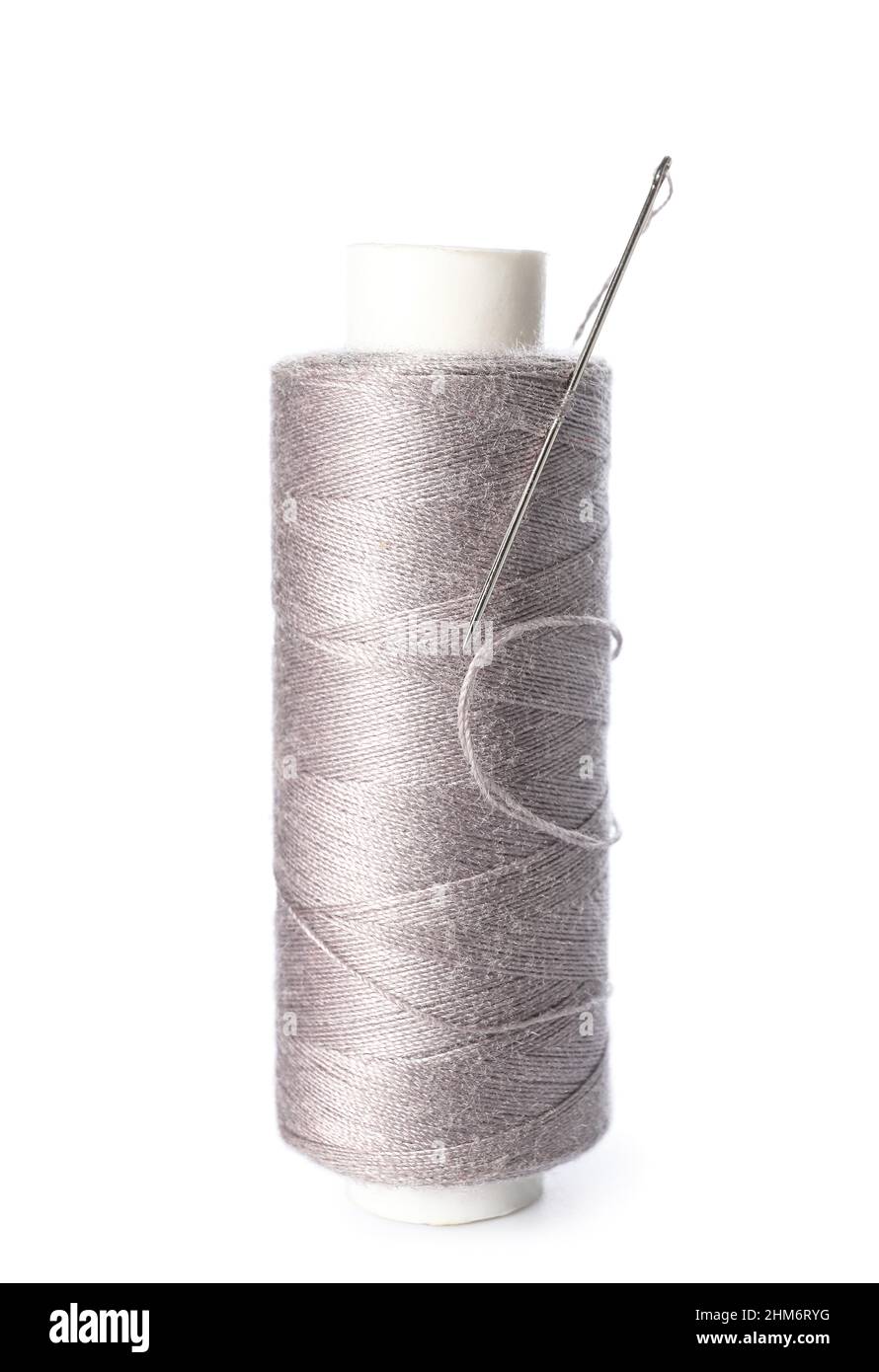 Grey sewing thread spool with needle on white background Stock Photo ...
