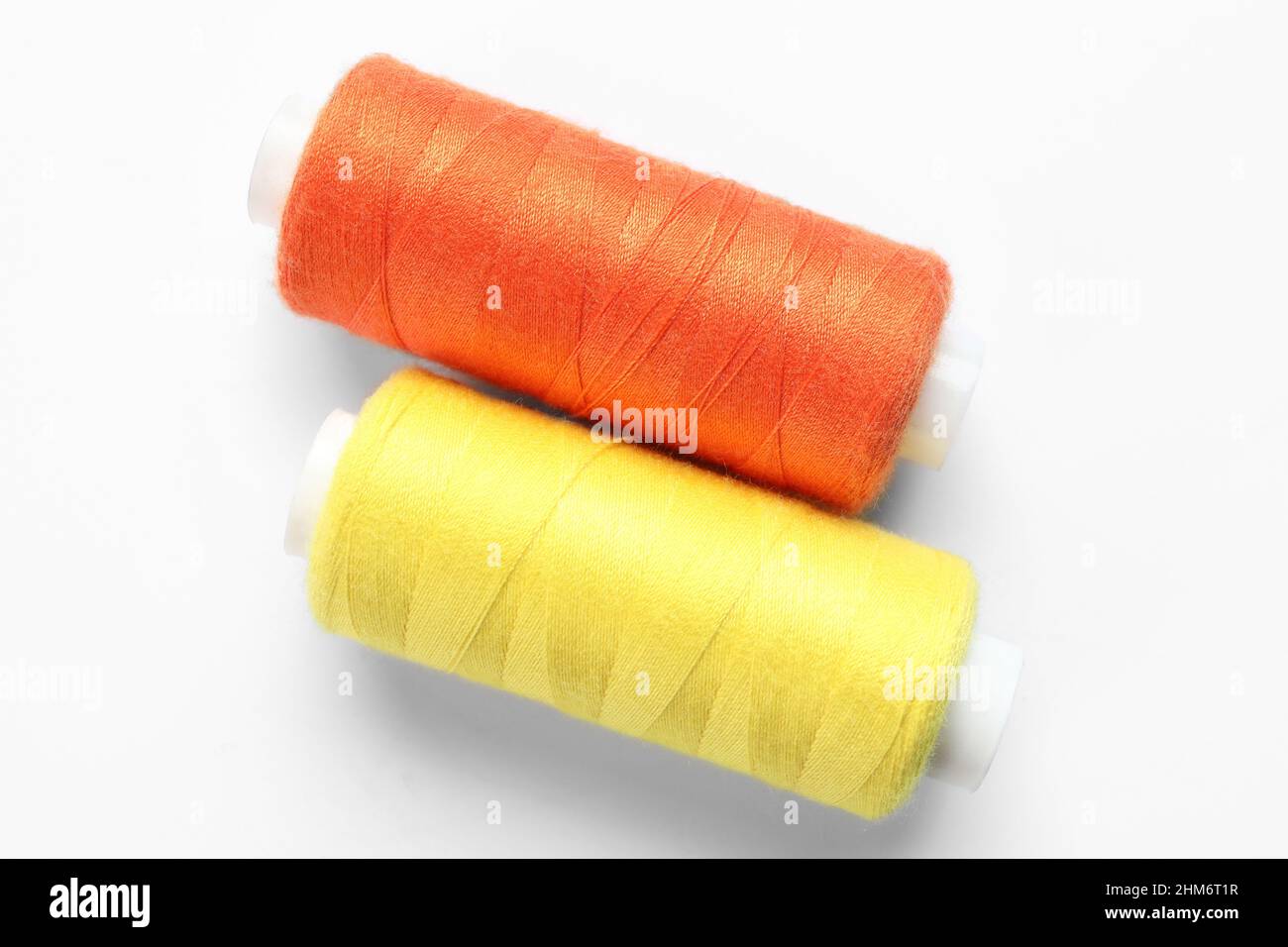 Beautiful sewing threads on white background Stock Photo - Alamy