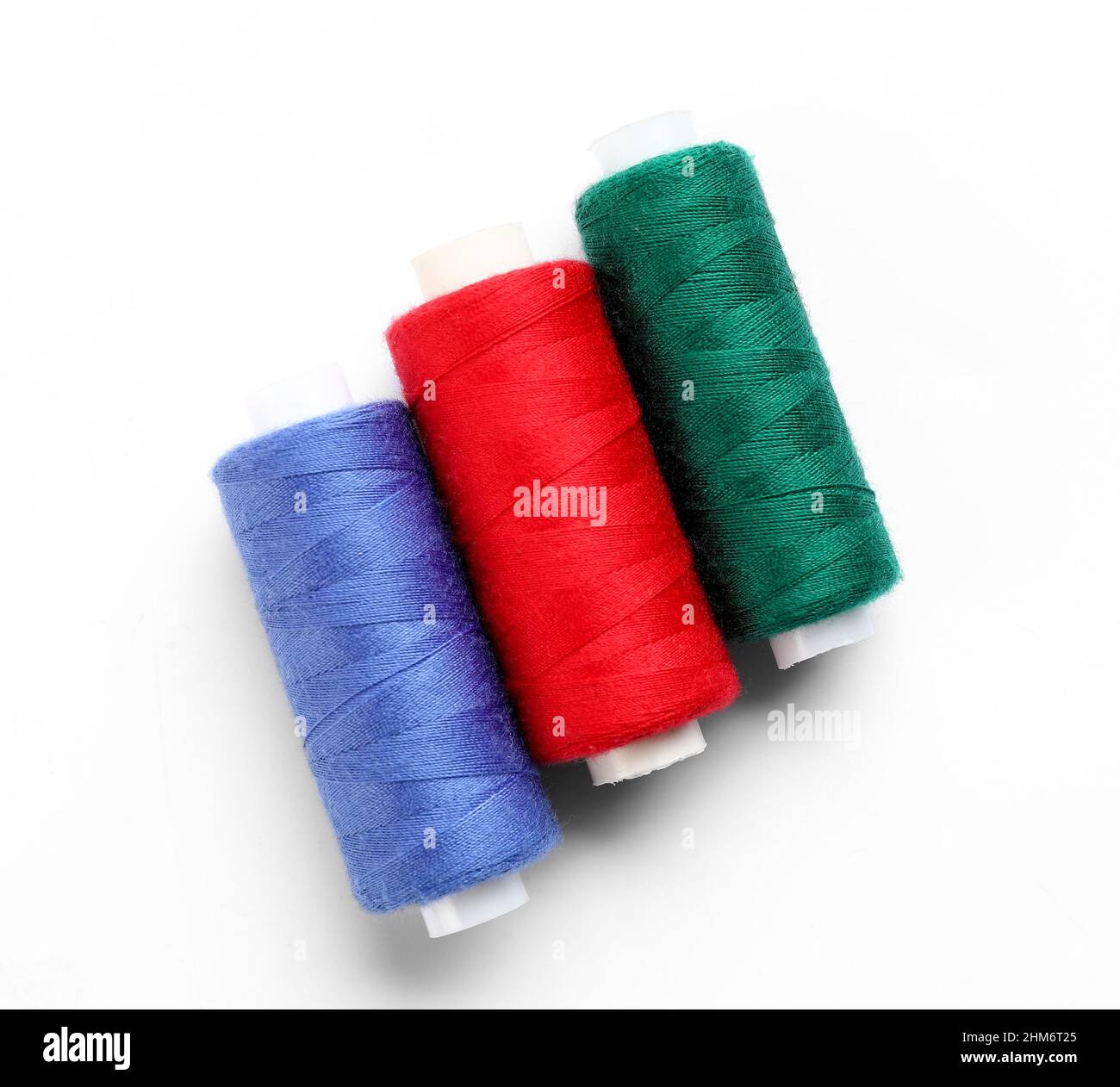 Beautiful sewing threads on white background Stock Photo - Alamy