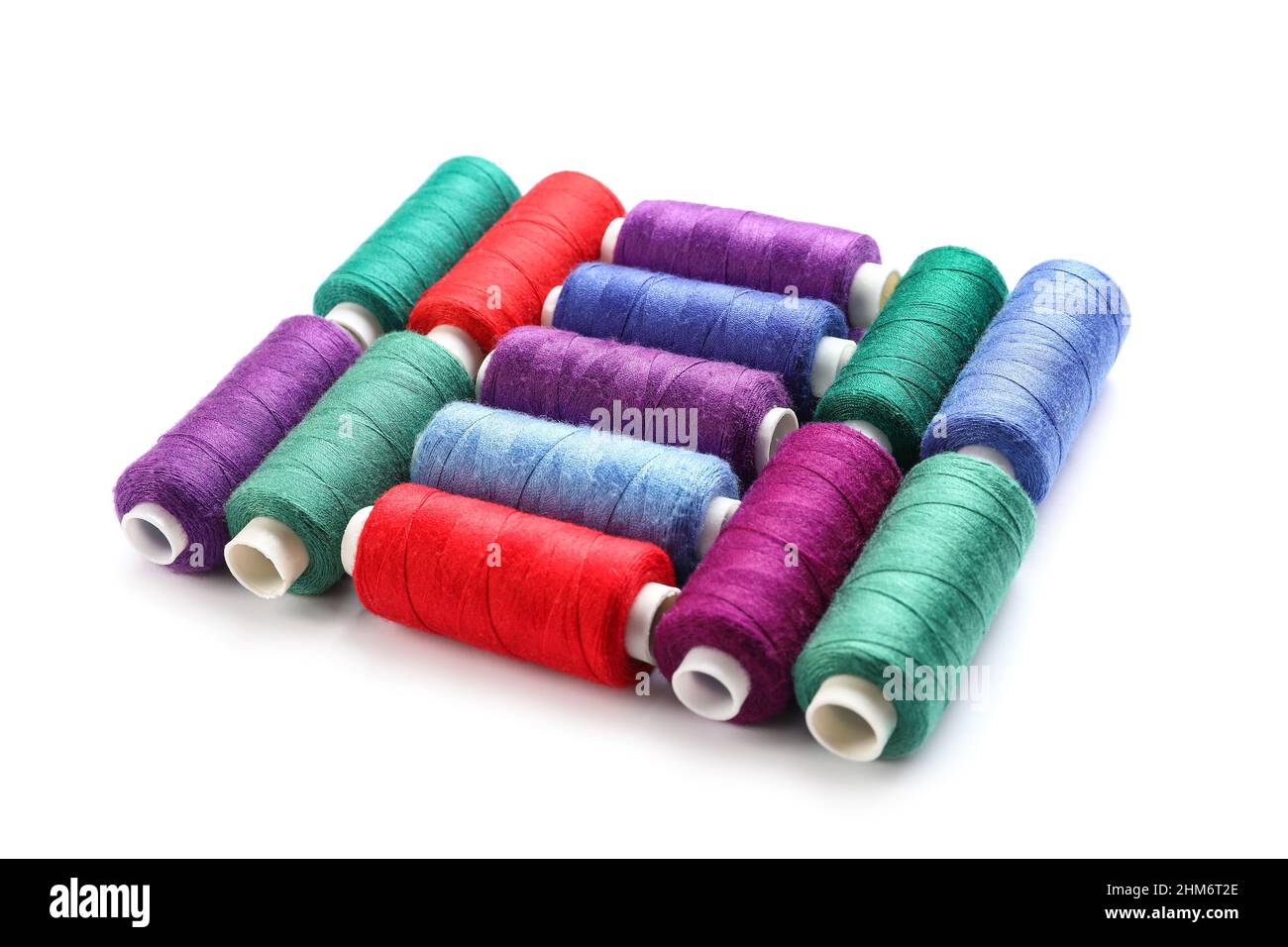 Beautiful sewing threads on white background Stock Photo - Alamy
