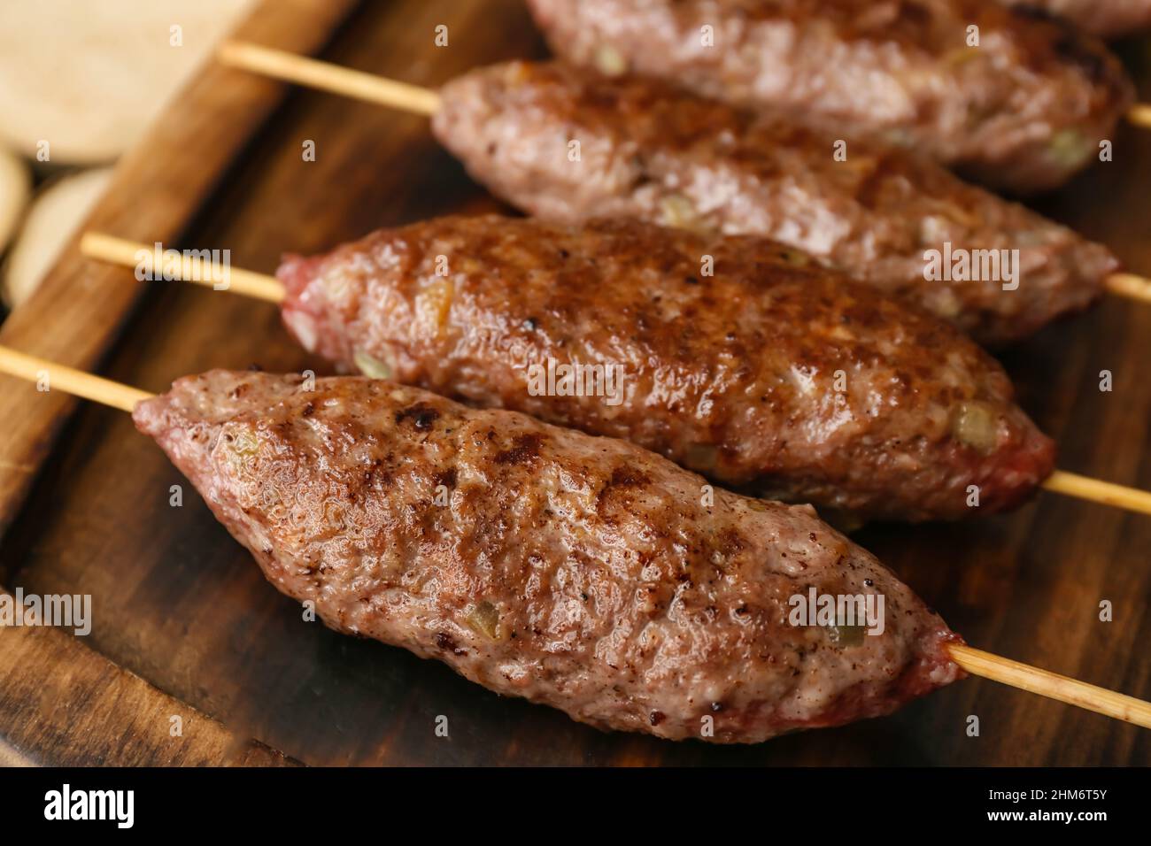 Wooden board of skewers with tasty lula kebab on table, closeup Stock ...