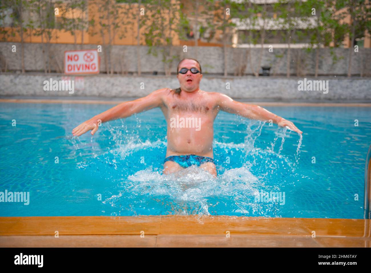 handsome sportsman is jumping in the big pool Stock Photo - Alamy