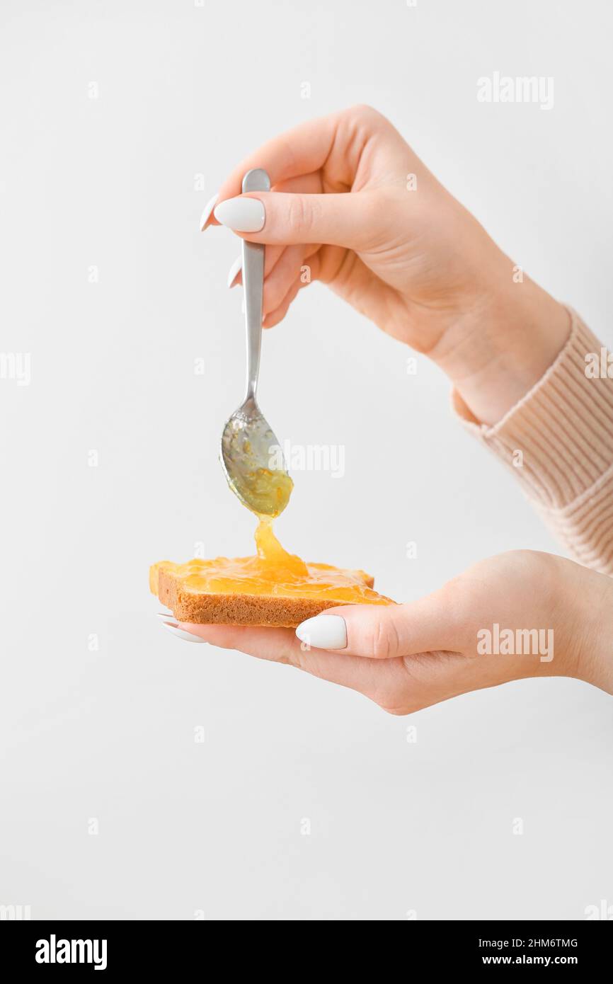 Hands female spreading jam toast hi-res stock photography and images ...