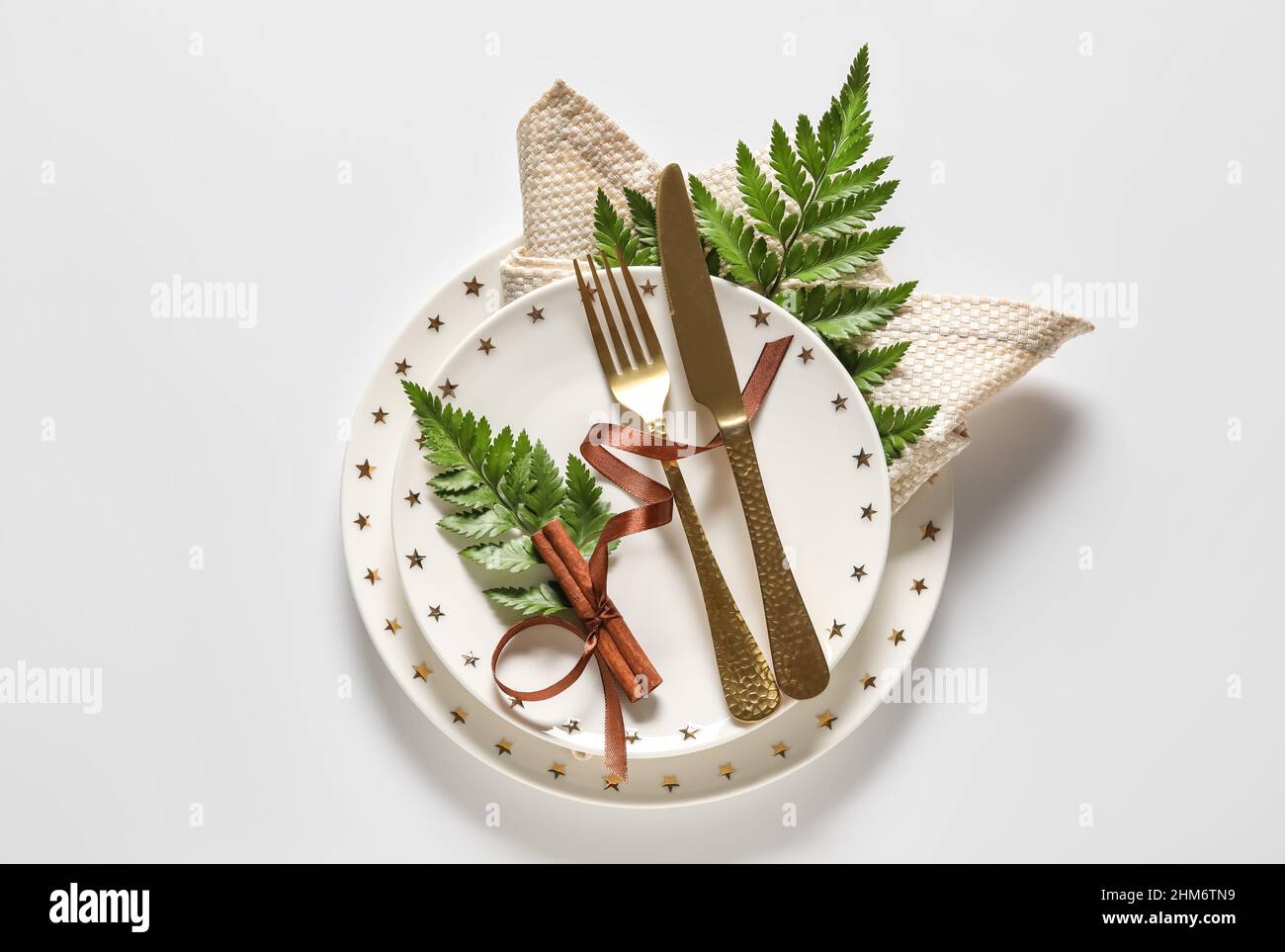 Stylish simple table setting and cinnamon on white background Stock ...