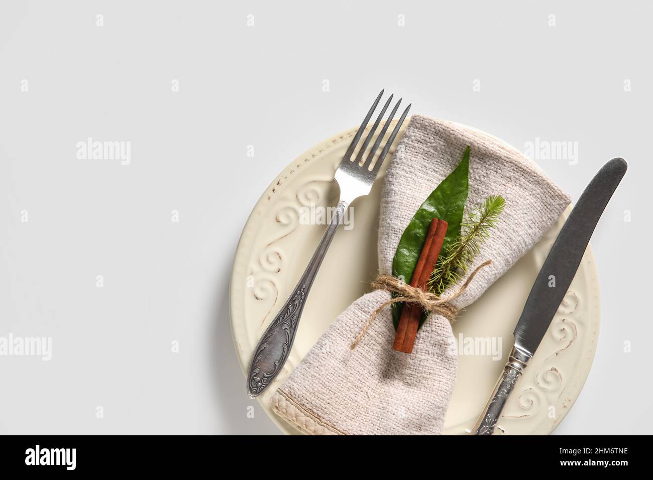 Stylish simple table setting and cinnamon on white background Stock ...