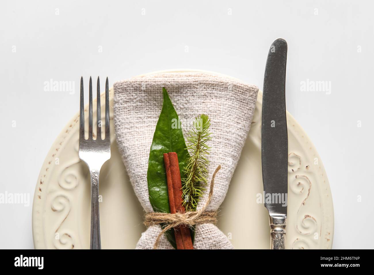 Stylish simple table setting and cinnamon on white background Stock ...