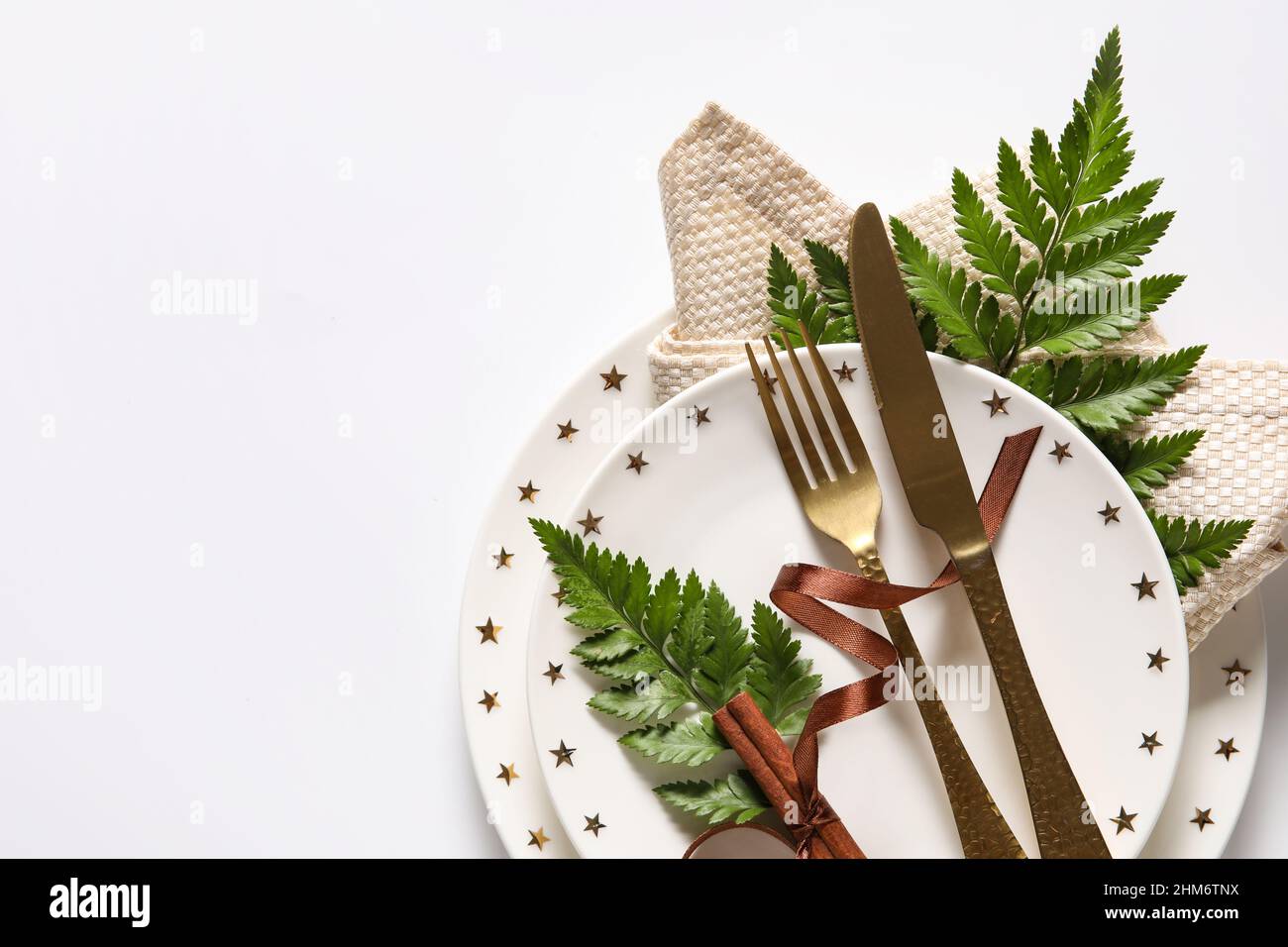 Stylish simple table setting and cinnamon on white background Stock ...