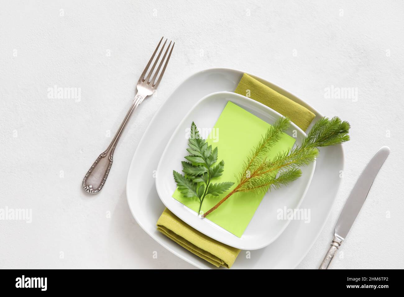 Stylish simple table setting on white background Stock Photo - Alamy