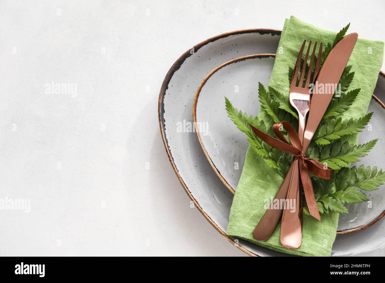 Stylish simple table setting on white background Stock Photo - Alamy