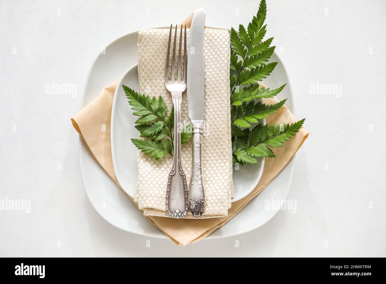 Stylish simple table setting on light background Stock Photo - Alamy