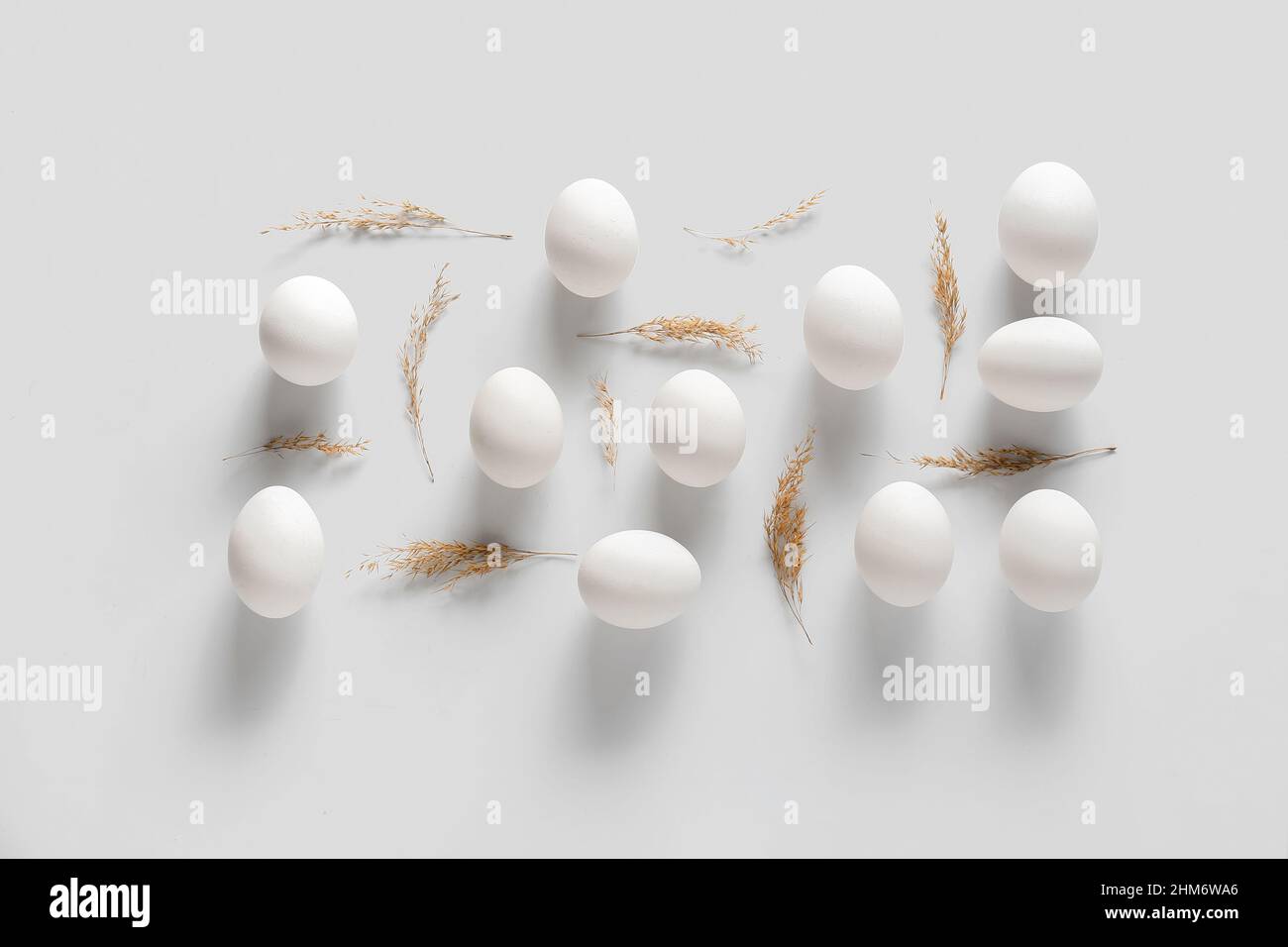 Easter eggs and reed branches on white background Stock Photo - Alamy