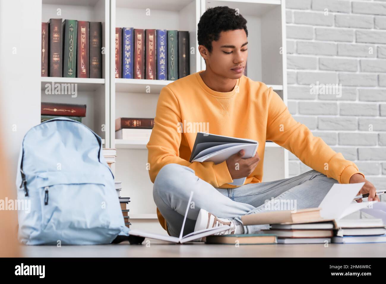 Male African-American student studying in library Stock Photo - Alamy