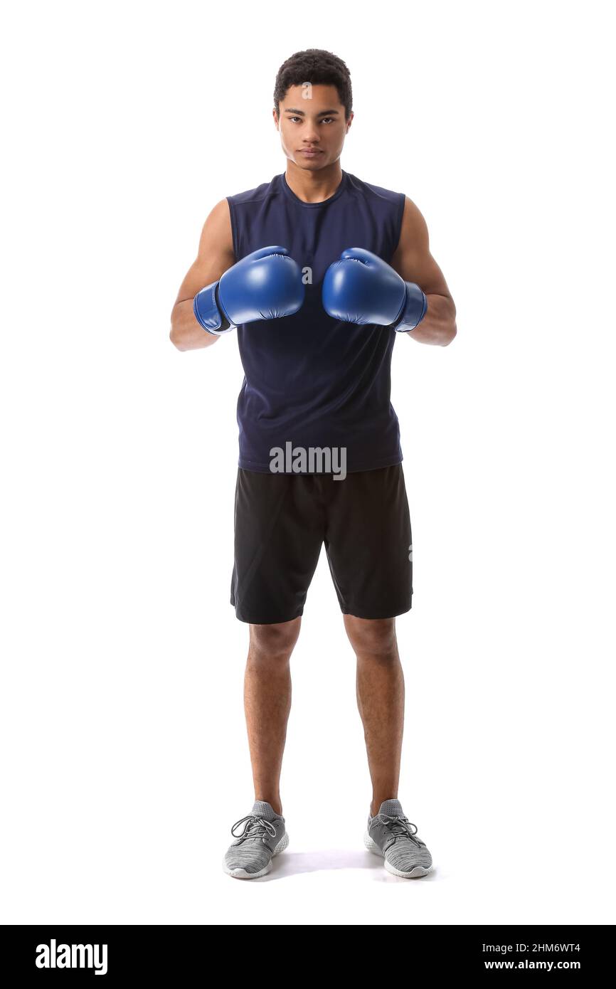 Young African-American man with boxing gloves on white background ...