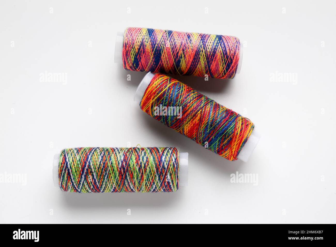 Different thread spools on white background Stock Photo - Alamy