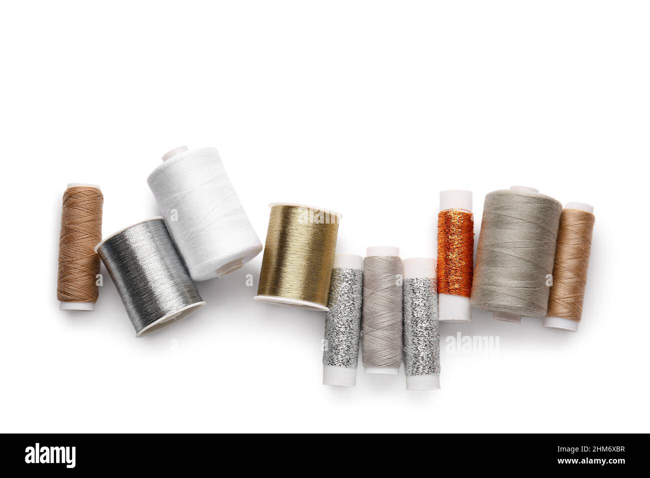 Different thread spools on white background Stock Photo - Alamy