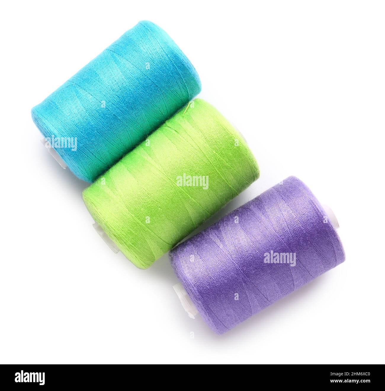 Different thread spools on white background Stock Photo - Alamy