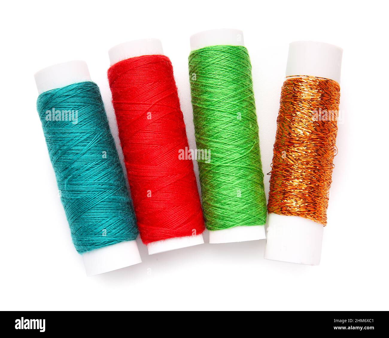 Different thread spools on white background Stock Photo - Alamy