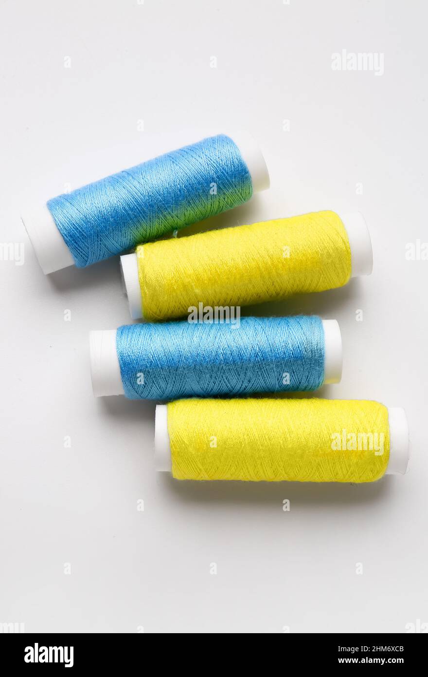 Different thread spools on white background Stock Photo - Alamy