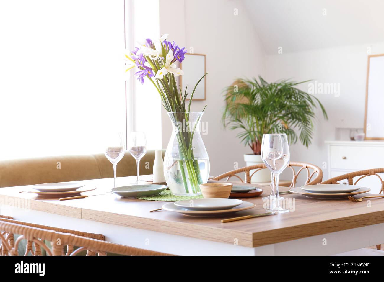 Dining table with setting and beautiful iris flowers for International ...