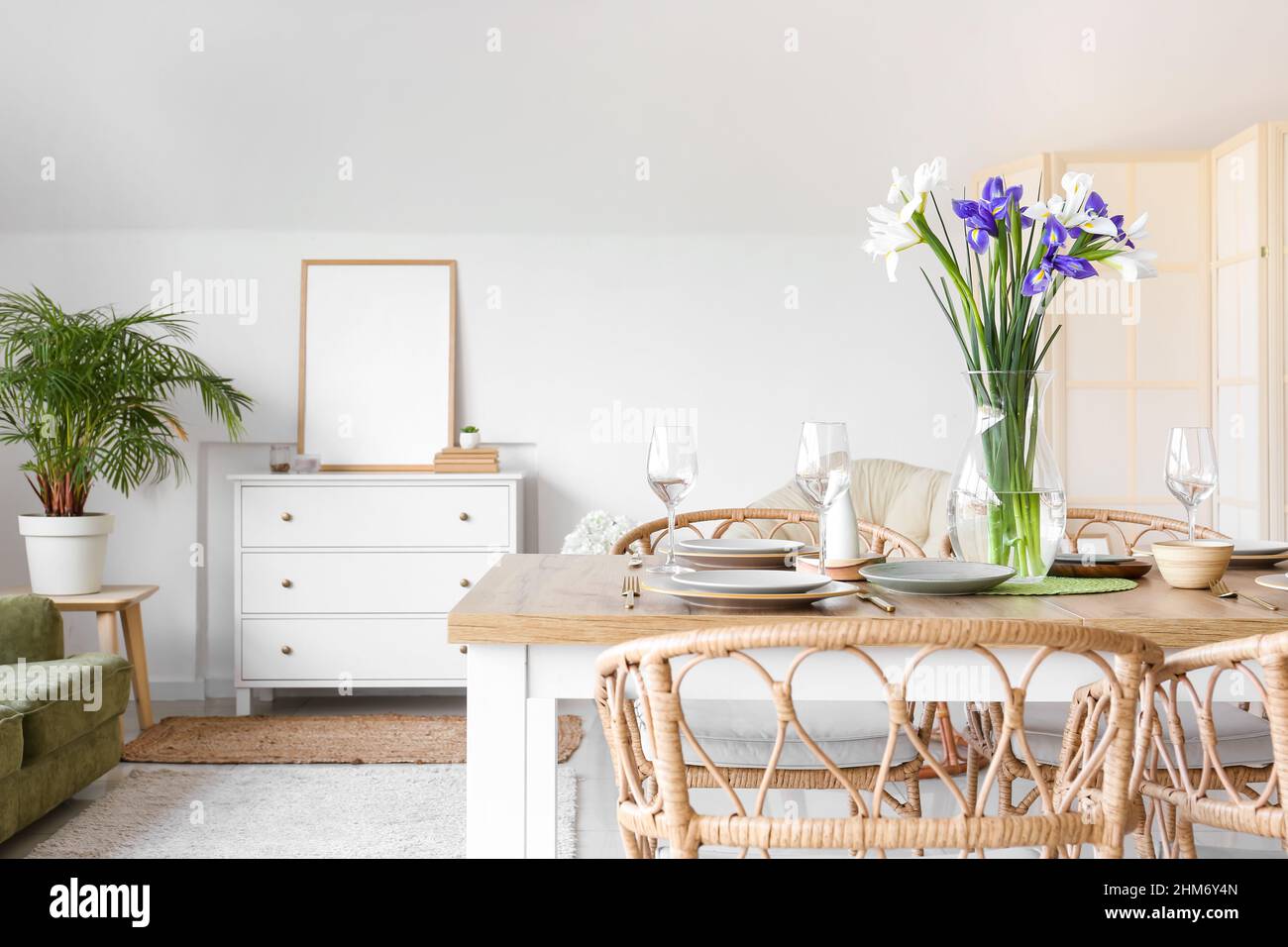 Beautiful setting and vase with iris flowers on dining table served for ...