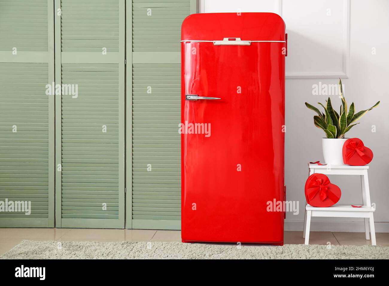 Stylish red fridge and stepladder stool with gift boxes for Valentine's ...