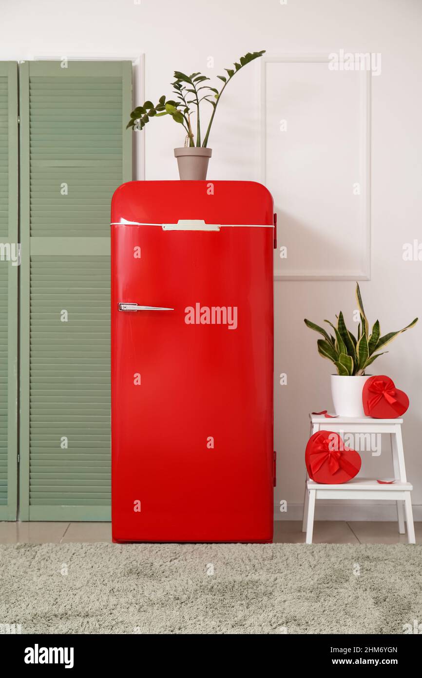 Stylish red fridge and stepladder stool with gift boxes for Valentine's ...