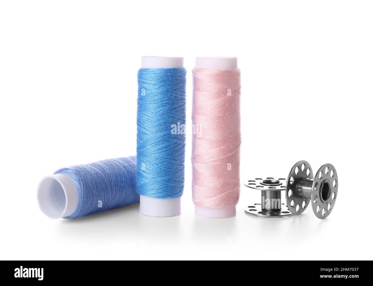 Different thread spools on white background Stock Photo - Alamy