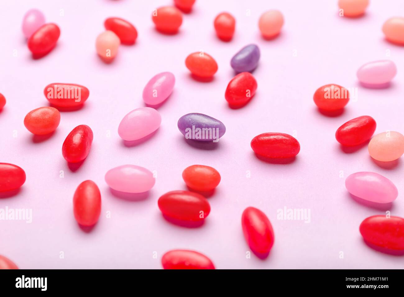 Different jelly beans on pink background, closeup Stock Photo - Alamy