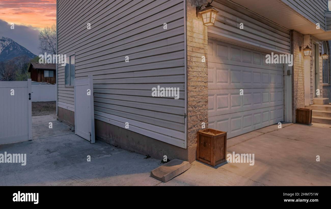 Panorama Dramatic sunset with clouds Side view of a two storey house ...