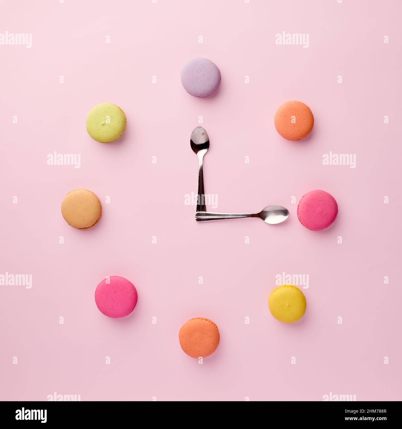 A clock made of pastel colored macarons and teaspoons. Snack time ...