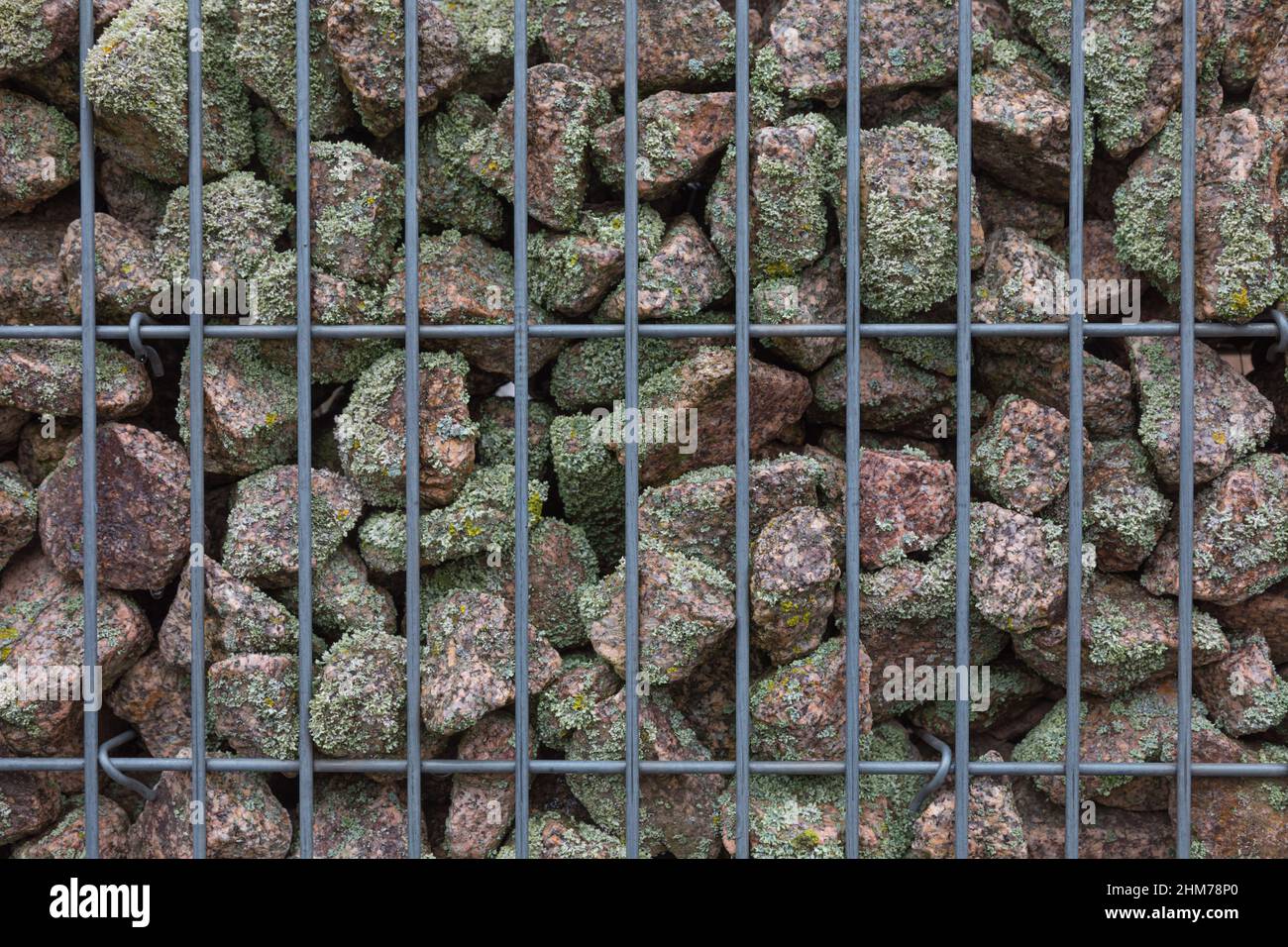 Front view of big heavy stones behind the fence Stock Photo - Alamy