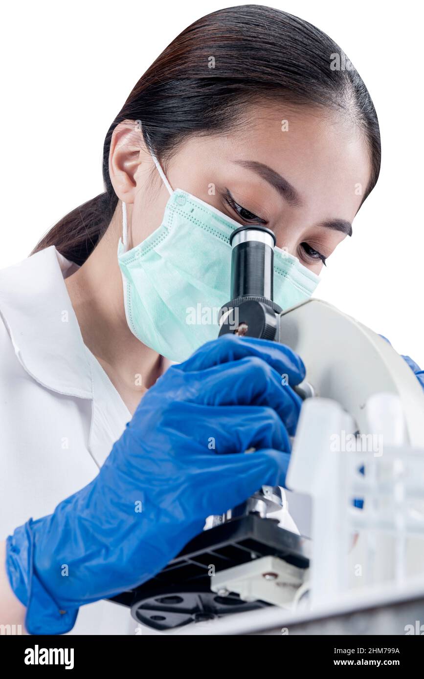 Asian researcher woman with face mask and glasses using microscope ...