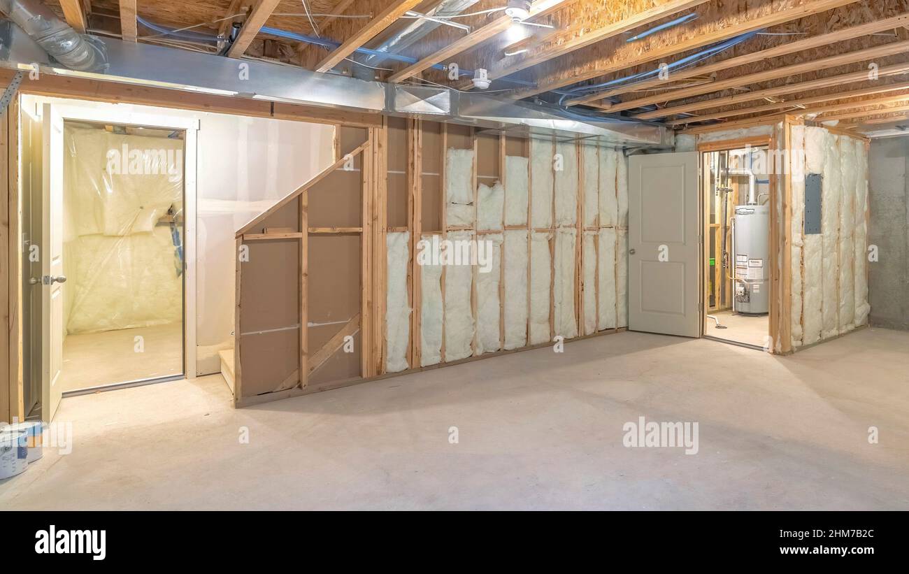 Panorama Empty unfinished large basement with concrete flooring and ...