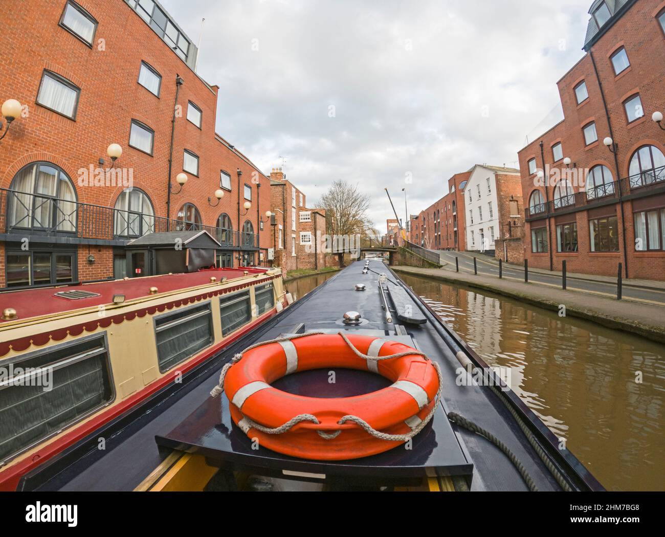 View from narrowboat traveling through English urban scenery on British ...