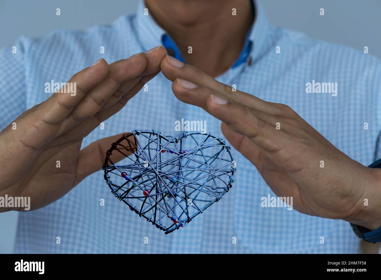 Man's Hand Guarding an Iron Heart Love business insurance concept Stock ...