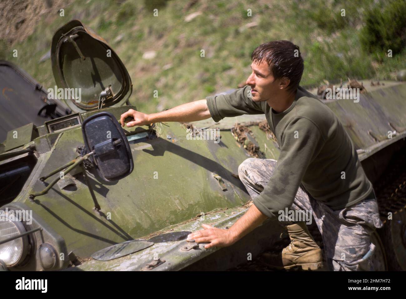 Soldier near the damaged armored personnel carrier Stock Photo - Alamy