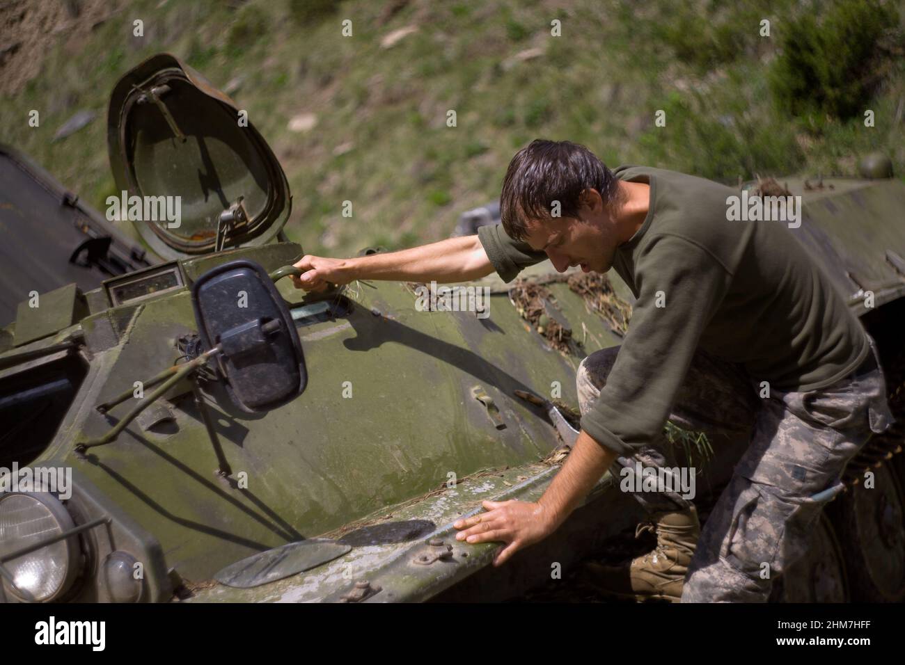 Soldier near the damaged armored personnel carrier Stock Photo - Alamy